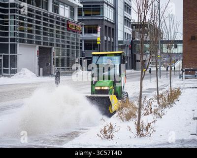 A worker clears a sidewalk in downtown Pittsburgh, Sunday, Jan. 25 ...