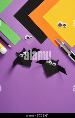 Black paper bats on yellow and white background. Halloween greeting ...