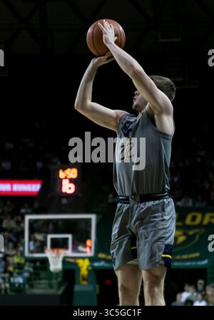West Virginia guard Sean McNeil advances the ball against Baylor during ...