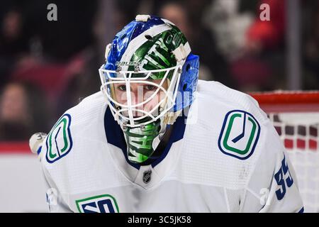 Vancouver Canucks goalie Thatcher Demko (35) watches as teammate Jake ...