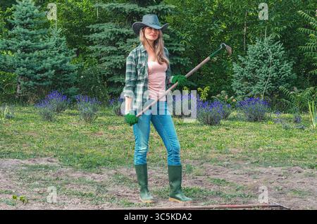 Woman farmer standing in her lavender field at sunset Stock Photo - Alamy