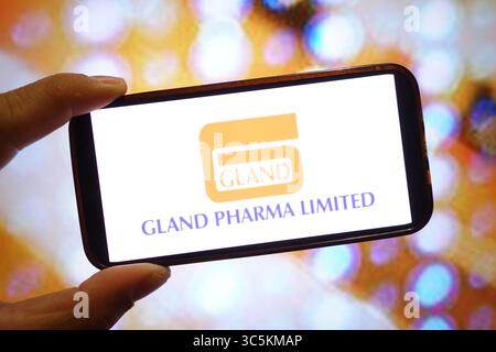 In this photo illustration, the Gland logo is displayed on the screen ...