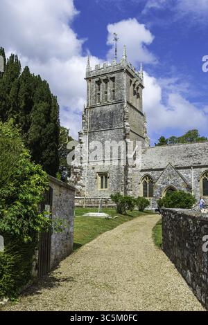 Stone church entrance framed by ancient trees in Huntingdonshire ...