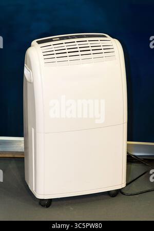 Modern machine of air conditioner on a green wall Stock Photo - Alamy