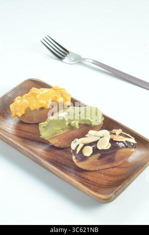 Pukis cake with various toppings of chocolate, cheese, peanuts, and ...