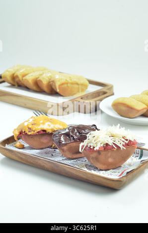 Pukis cake with various toppings of chocolate, cheese, peanuts, and ...