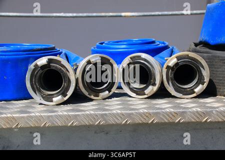 Blue hoses with Storz couplings lie on a sheet Stock Photo - Alamy