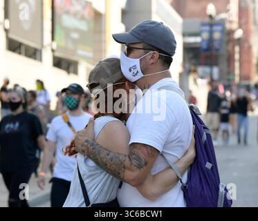 Two protesters hug each other during the demonstration. Seven days have ...
