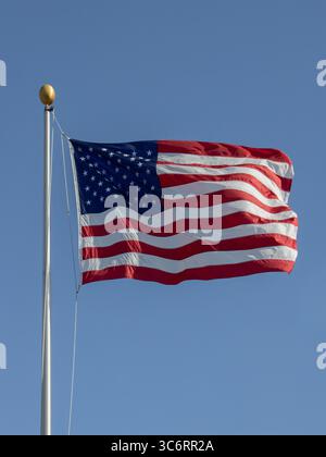 A closeup shot of an American flag in a bouquet near a fence Stock ...