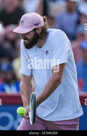 Learner Tien, of the United States plays a backhand return to Lorenzo ...