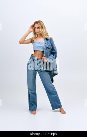 Blonde woman showcases her trendy denim outfit with confidence and ...