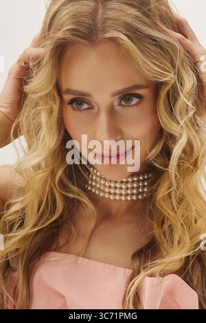 Joyful blonde woman showcases her denim fashion while playfully ...