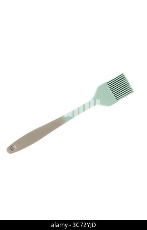 A Green Kitchen Silicone Brush on a hand isolated on a Black Background ...