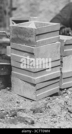 A construction worker carefully installs ventilation blocks, creating ...