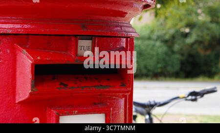 Close up of iconic red British mailbox used for traditional UK postal ...