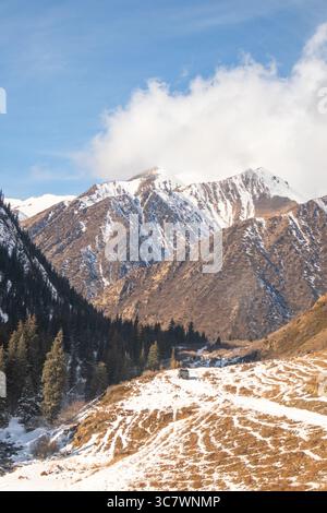 Car driving on the snowcapped road with skis on the roof rails in the ...
