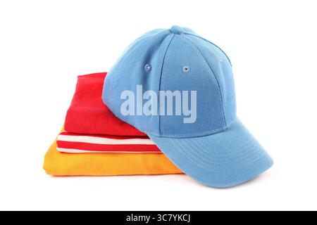 Light blue baseball cap and stack of folded t-shirts isolated on white ...