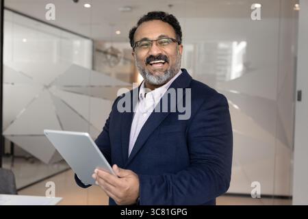 Happy and confident businessman using tablet Stock Photo - Alamy