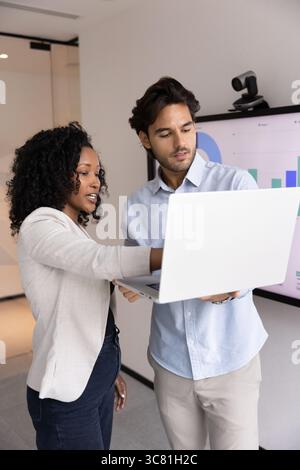 Diverse team collaborating on app design in office - Conceptual ...