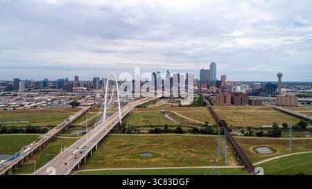 A high-angle drone shot of skyscrapers and a wide highway in ...