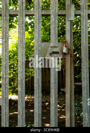 Locked barred steel gate, entrance to secret passage Stock Photo - Alamy