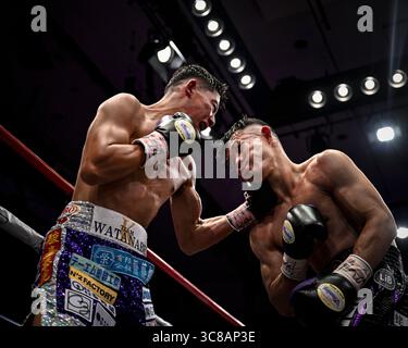 Champion Kai Watanabe (L) and challenger Reo Saito compete during their ...