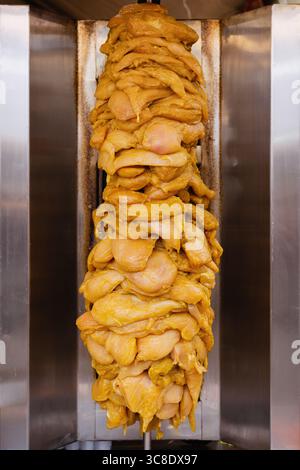Chicken shawarma grilling a vertical spit. Traditional Turkish food ...