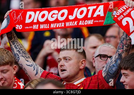 A fan holds up a Diogo Jota scarf during the Premier League match ...