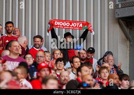 A fan holds up a Diogo Jota scarf during the Premier League match ...