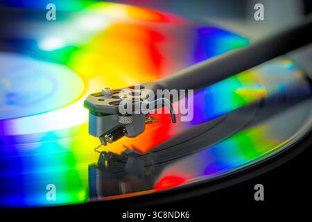 wonderful bright rainbow colored lights reflect off a vinyl record ...