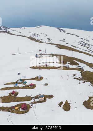 Aerial view of snow-covered Goderdzi Pass speckled with small ...