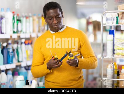 Supermarket shopping - man selects various nuts in produce section ...