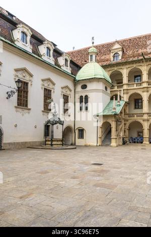 Ornate white building exterior with arched windows under a vivid blue ...