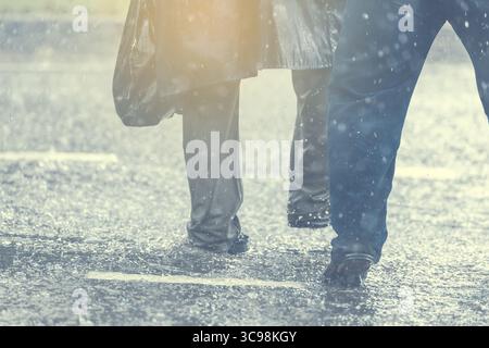 People running away through puddle at street during heavy rain Stock ...