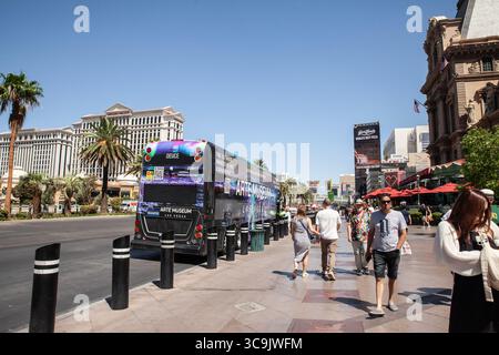 Commuters walk past a bus stop near Nine Elms Station as activists put ...