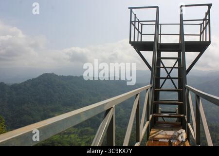 A modern metal viewpoint structure on a hilltop offers a stunning, wide ...