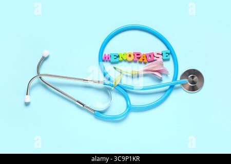 Word MENOPAUSE with flower on blue background Stock Photo - Alamy