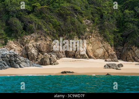 Secluded Cacaluta Beach can only be reached by boat. Huatulco National ...
