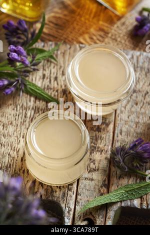 Strained hot rendered pork lard in which fresh comfrey root has been ...