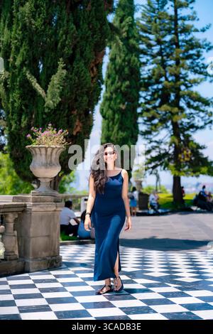happy young woman with long wavy brunette hair with yellow ...