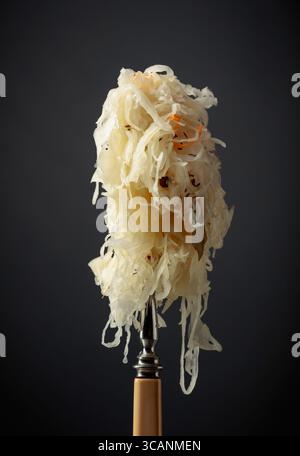 Homemade sauerkraut with carrot, black pepper and parsley in bowl on ...