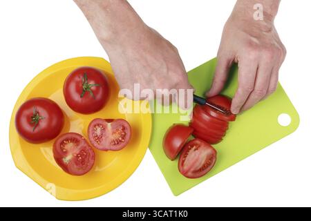 A top view of a chef slicing tomatoes on a wooden board Stock Photo - Alamy