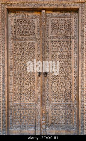 Ornate carved wooden door with geometric Islamic patterns at Hazrat ...