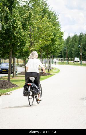 People enjoying a leisurely bicycle ride in rural Austria on a summer's ...