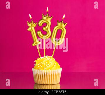 Pink number 130 birthday candle lit on white background Stock Photo - Alamy