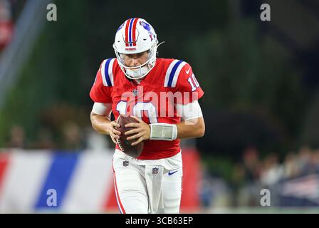 New England Patriots quarterback Mac Jones (10) warms up during an NFL ...