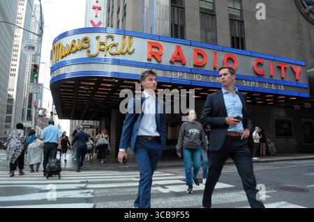 People walk past Radio City Music Hall in Manhattan, New York City ...