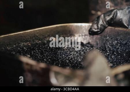 Preparation of asphalt from crushed stone and bitumen resin Stock Photo ...