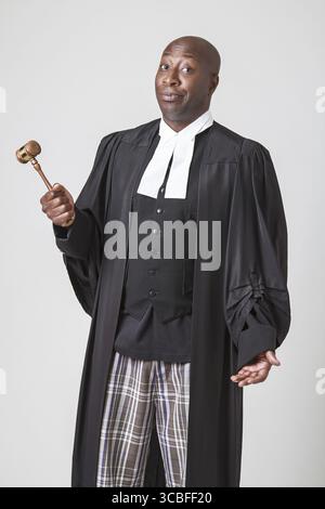 African American man wearing a bathrobe with surprise and happy emotion ...