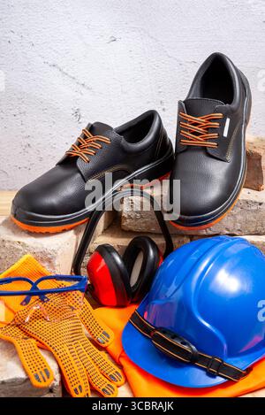 Earmuffs leather safety gloves on blue background construction concept ...